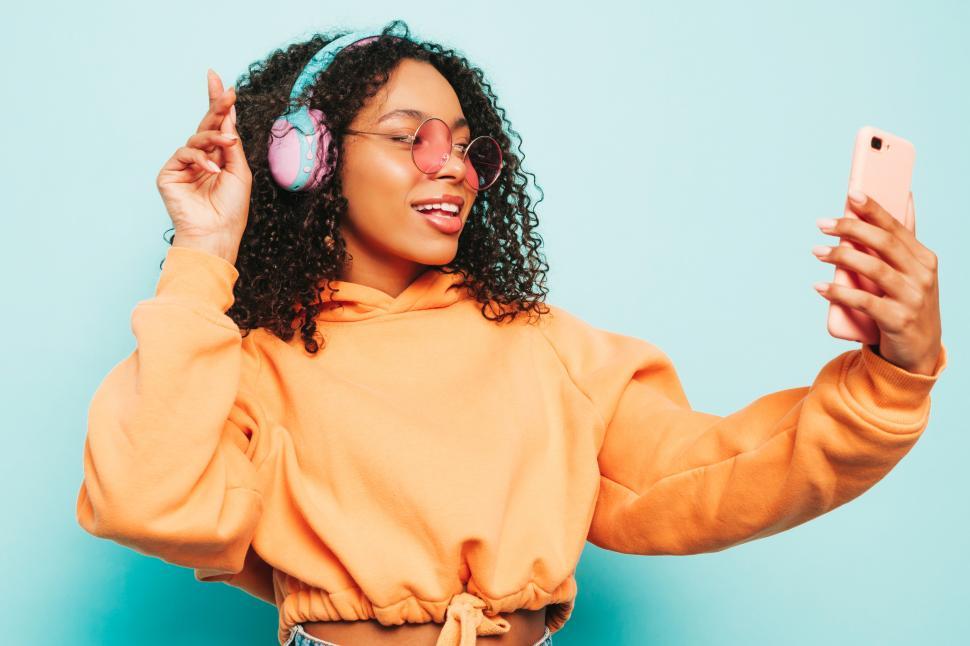 Free Stock Photo of Joyful woman taking selfie wearing orange top ...