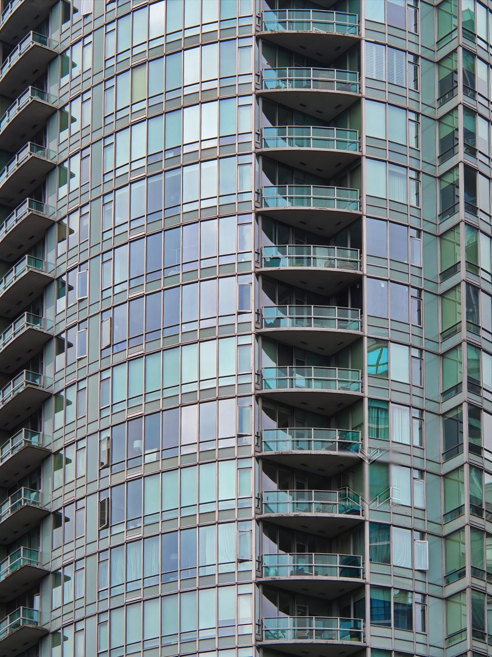 Free Stock Photo of Curved glass high-rise building with multiple ...