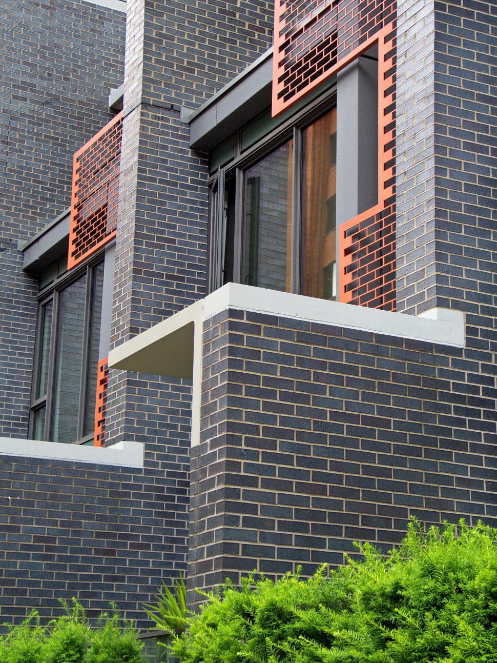 Free Stock Photo of Gray and black building with orange lattice over ...