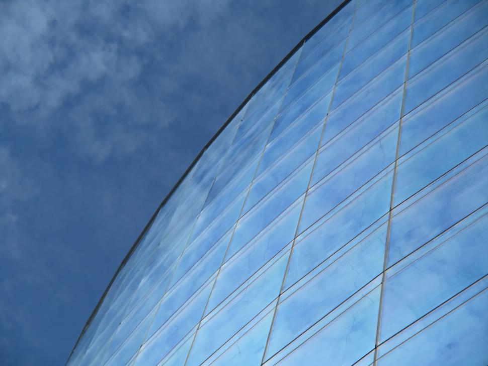 Free Stock Photo of Curved glass building reflecting blue sky and ...