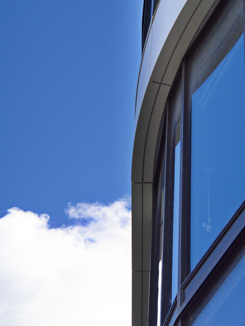 Free Stock Photo of Curved glass window against a clear blue sky with ...