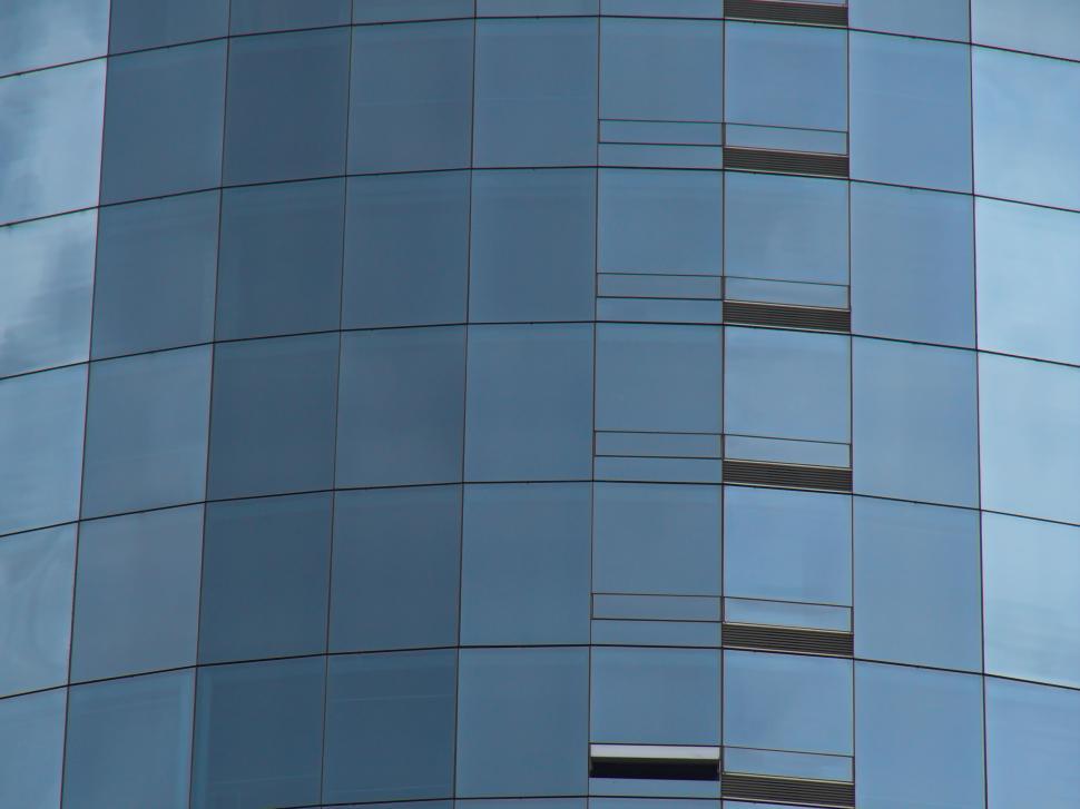 Free Stock Photo of Curved glass building facade with various window ...