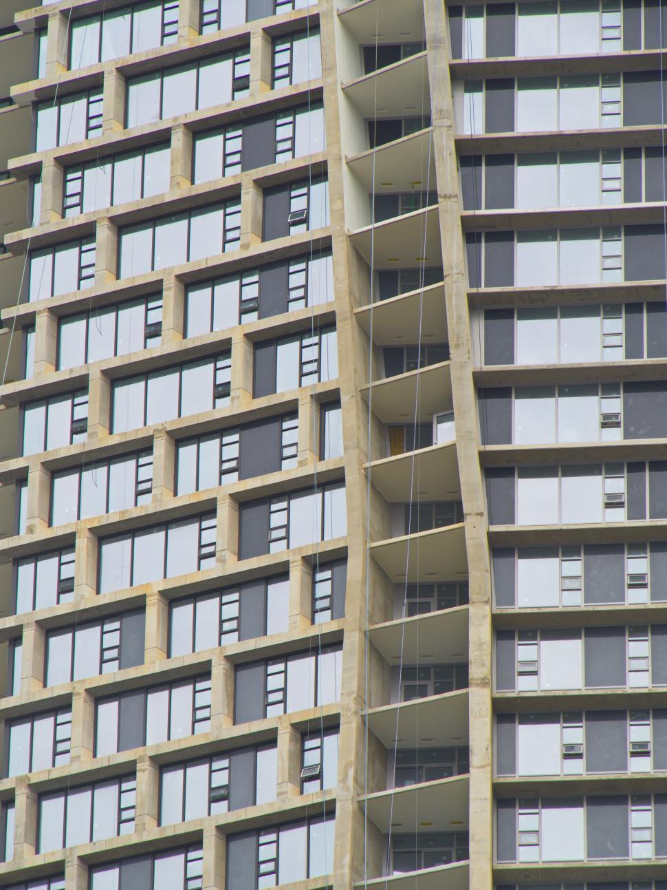 Free Stock Photo of Curved modern skyscraper with many windows and ...