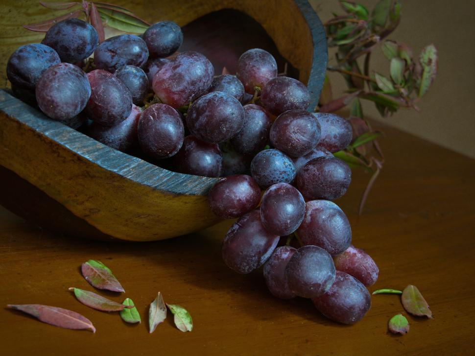 Free Stock Photo of Cluster of dark grapes spilling from the wooden ...
