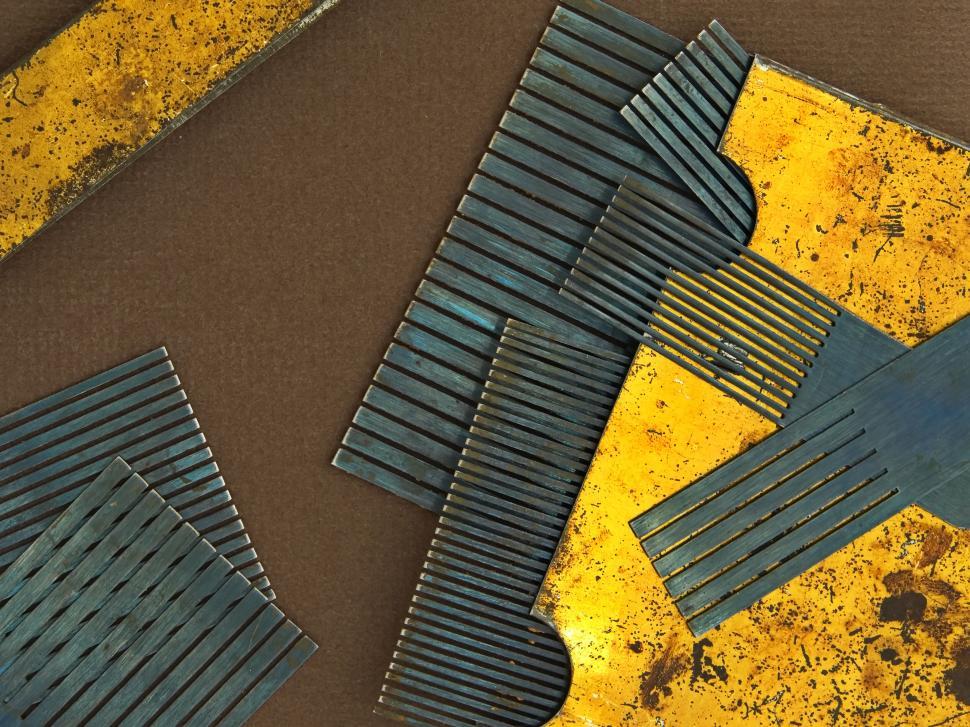 Free Stock Photo of Industrial metal combs on a brown background create ...