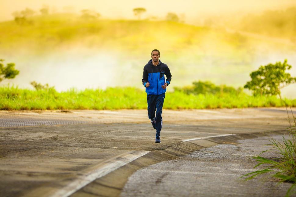 Free Stock Photo of Man jogging down a picturesque country road at ...