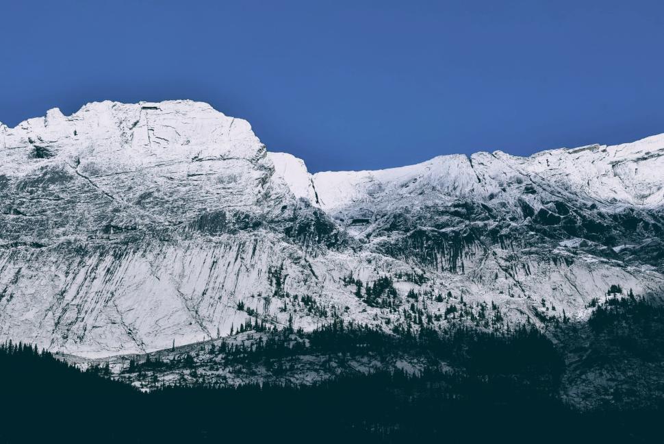 Free Stock Photo of Snow-covered mountain peaks under a clear blue sky ...