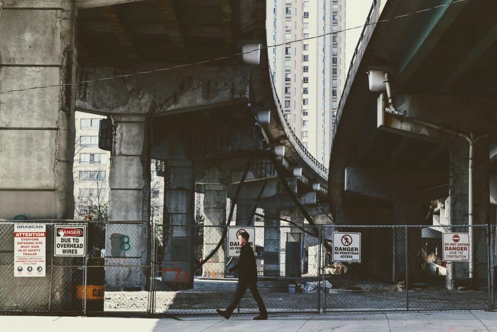 Free Stock Photo of Man walking under a bridge in an urban construction ...