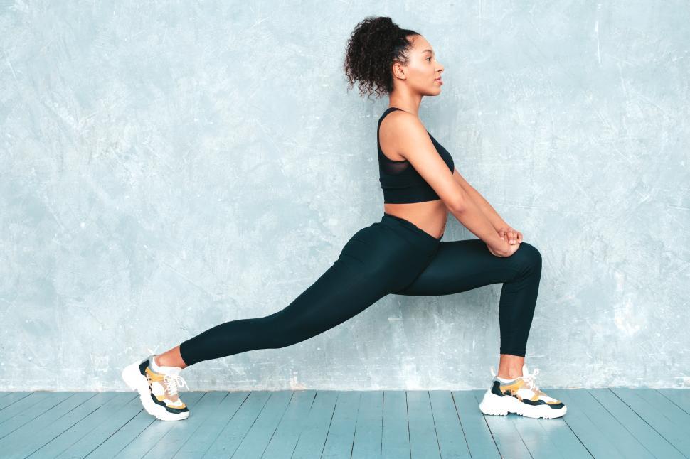 Free Stock Photo of Person doing a lunge stretch in black workout ...