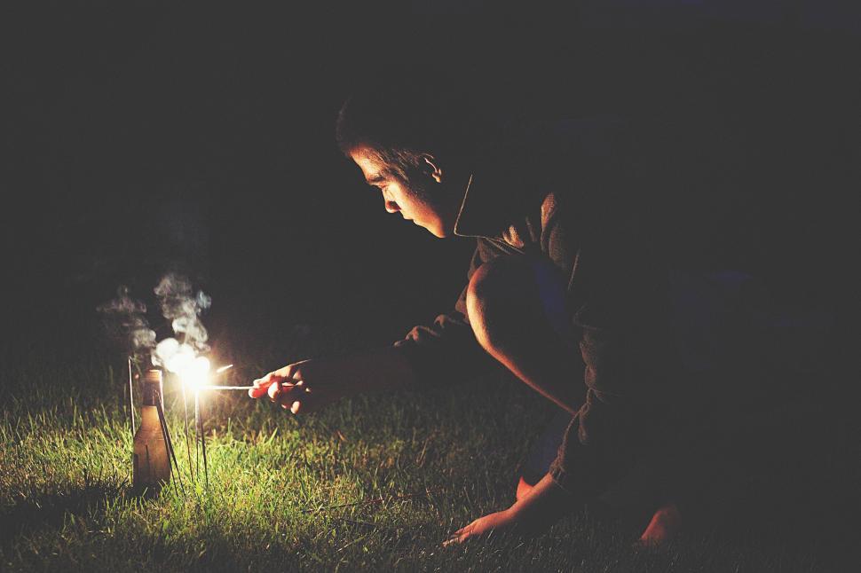 Free Stock Photo of Person lighting firework on the ground at night ...
