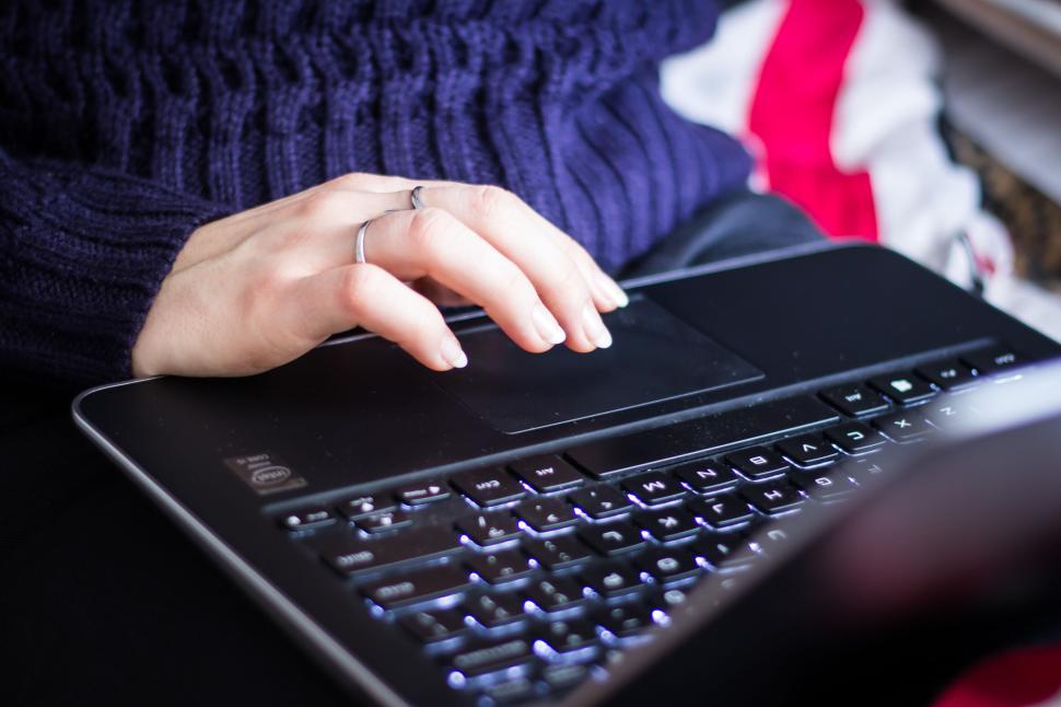 Free Stock Photo of Woman s hand using a laptop trackpad with a ring on ...