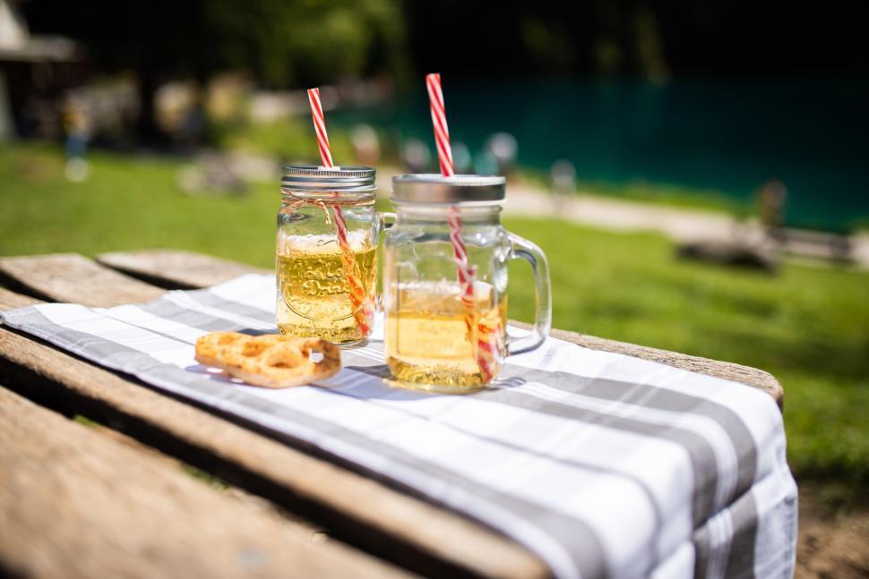 Free Stock Photo of Two mason jar drinks and a pastry on a picnic table ...