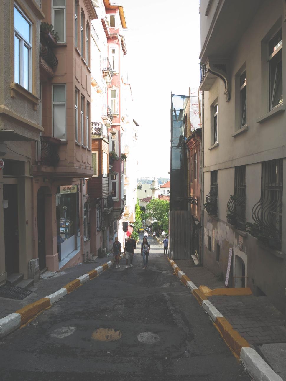 Free Stock Photo of Narrow urban street descending towards distant view ...
