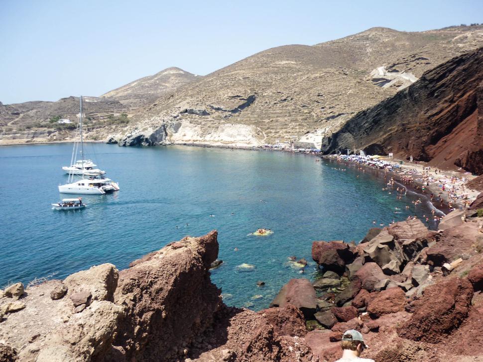 Free Stock Photo of Rocky cliffside overlooking a crowded beach with ...