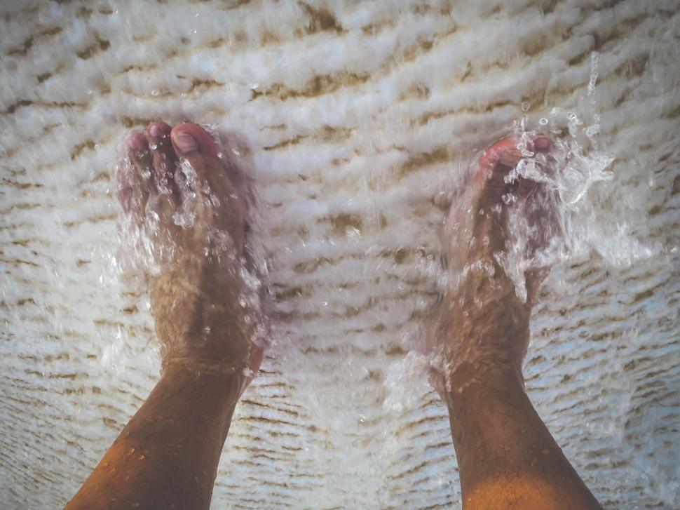 Free Stock Photo of Feet in flowing water over a sand-like textured ...