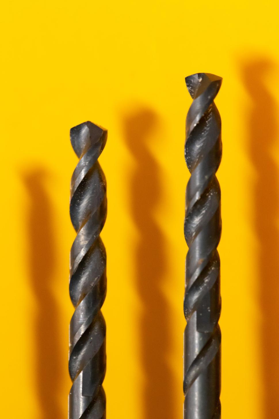 Free Stock Photo of Two metallic drill bits with yellow background ...