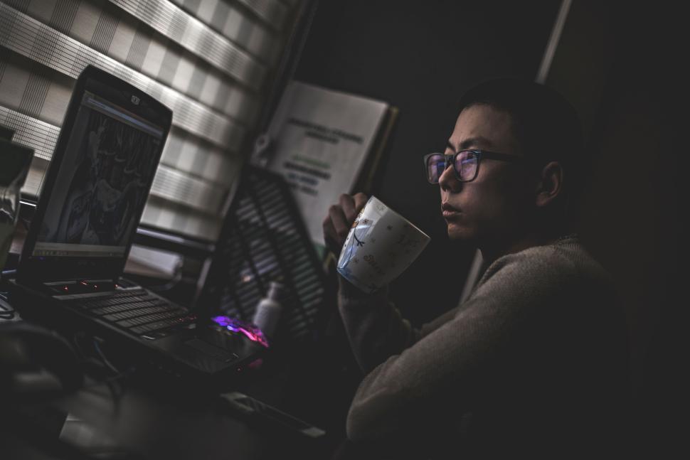 Free Stock Photo of Person drinking coffee while working on laptop at ...