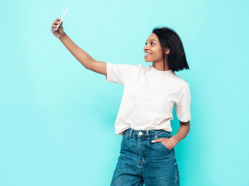 Free Stock Photo of Woman taking selfie, turquoise backdrop, white top ...
