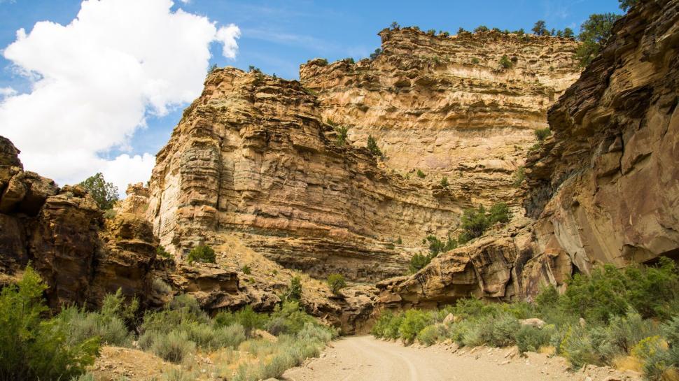 Free Stock Photo of Rugged canyon inviting explorers under clear blue ...