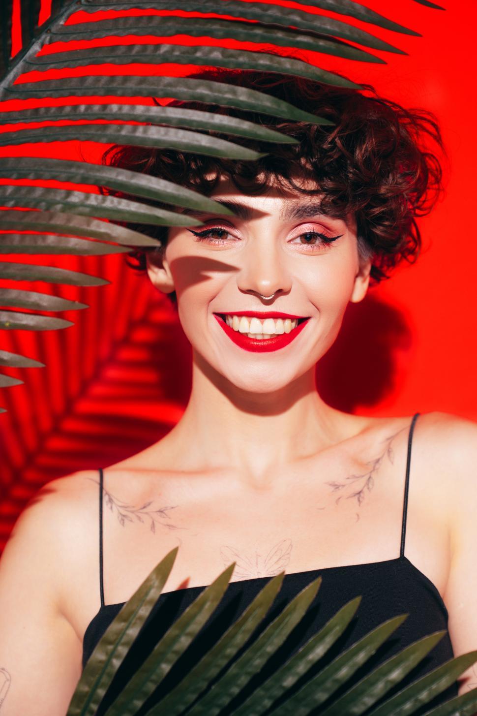 Free Stock Photo of Smiling woman with short hair in front of red backdrop | Download Free ...
