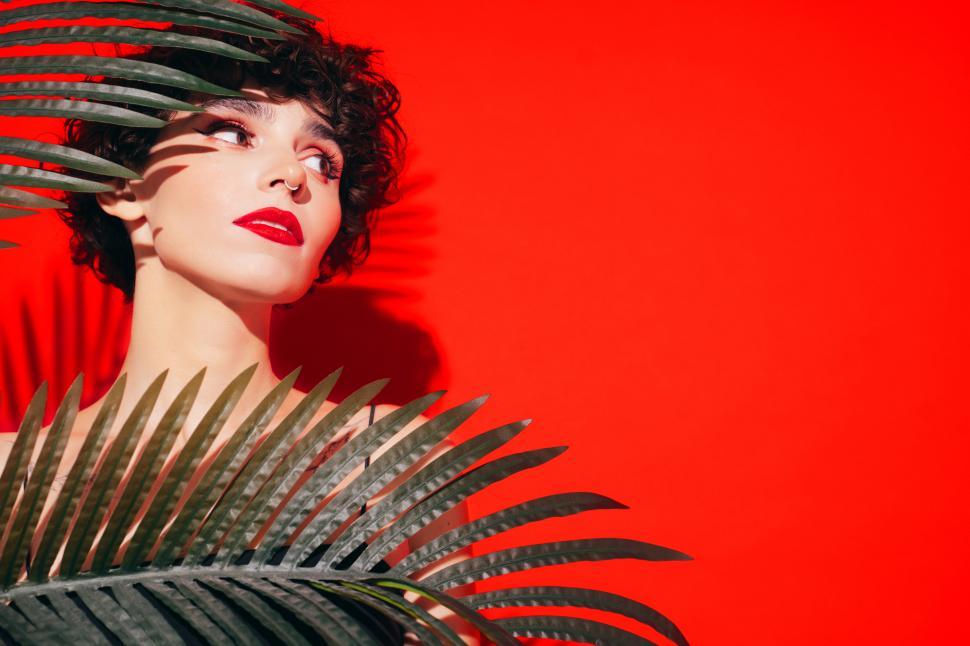 Free Stock Photo of Contemplative woman with palms against bright red ...