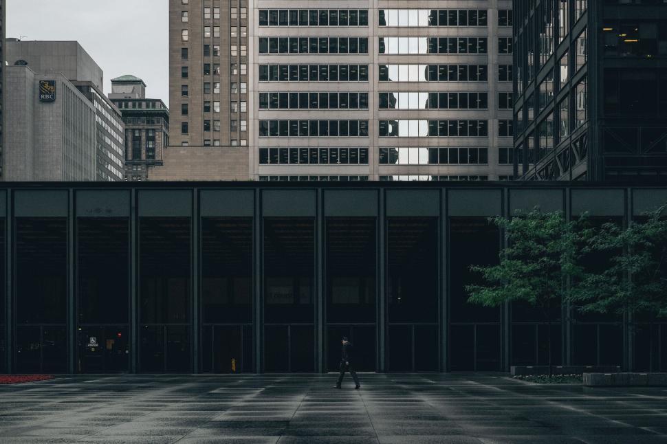 Free Stock Photo of Man walking in the rain near high-rise buildings ...