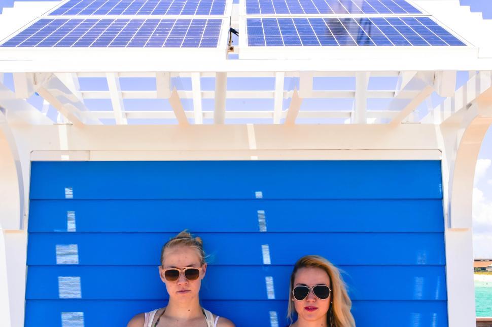 Free Stock Photo of Two women in sunglasses under solar panels on a ...