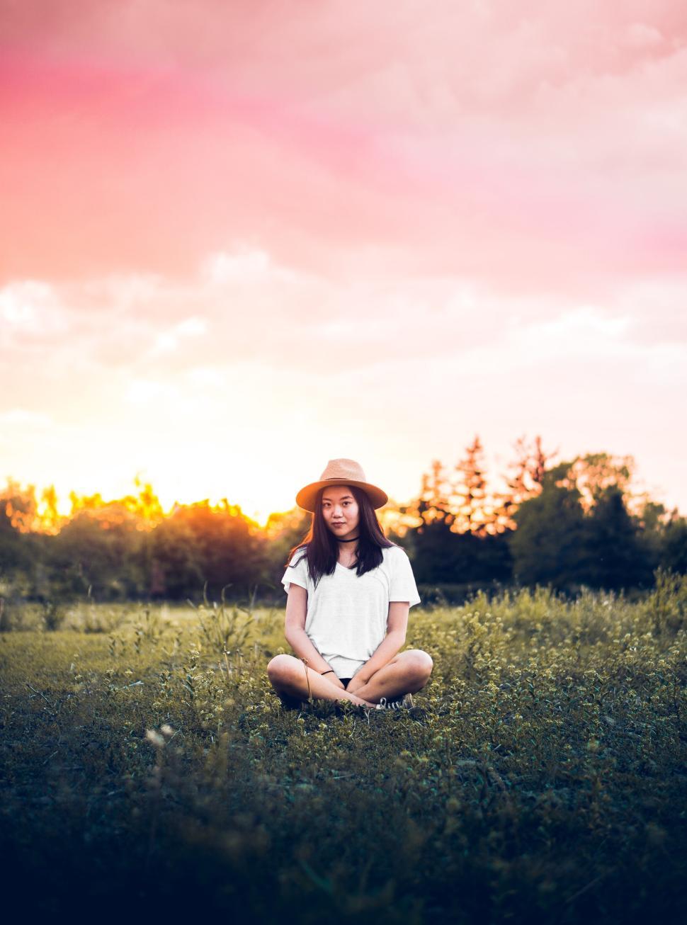 Free Stock Photo of Young woman sitting cross-legged in a field at ...