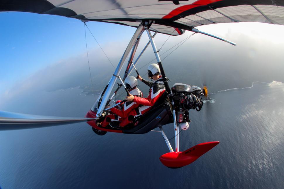 Free Stock Photo of Adventurers in a motorized hang glider soaring over ...