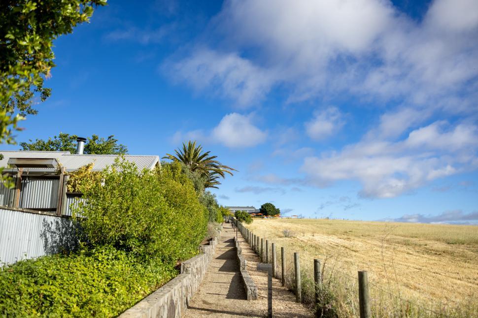 Free Stock Photo of Rural pathway beside a house with a blue cloudy sky ...