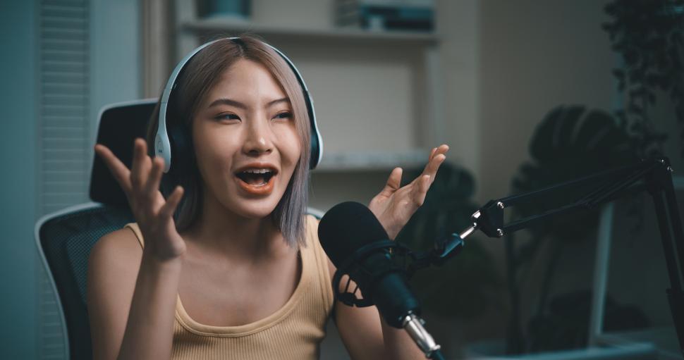 Free Stock Photo of Cheerful Young podcaster use microphone during ...