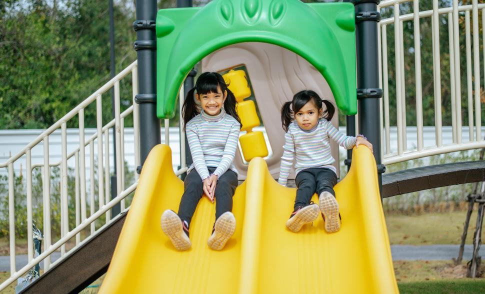 Free Stock Photo of Two girls play slides in the playground. | Download ...