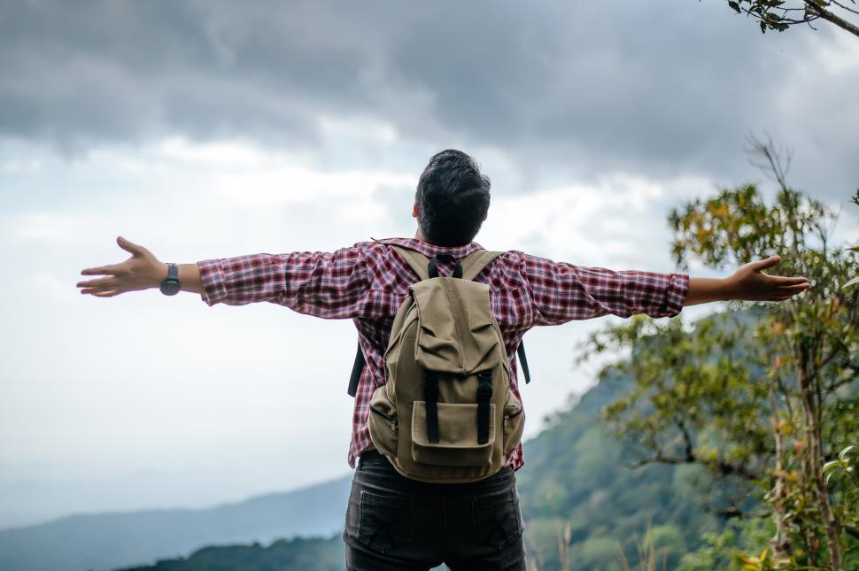 Free Stock Photo of Young trekking man standing on rocky mountain peak ...
