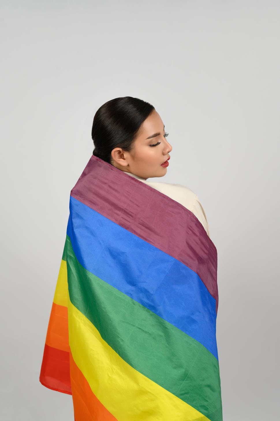 Free Stock Photo of Pretty woman poses with colorful gay pride flag on ...