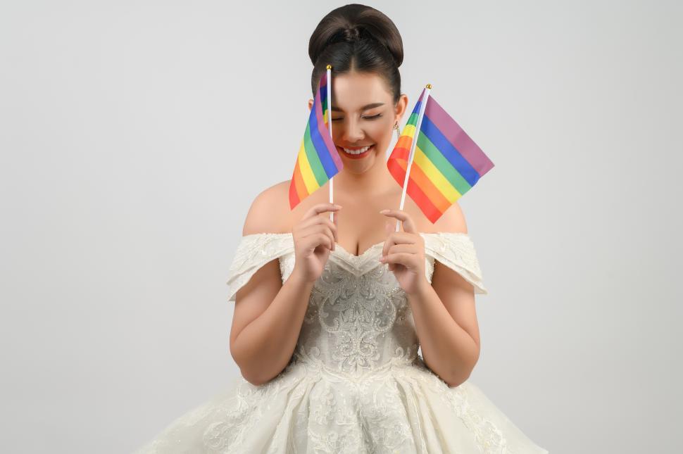 Free Stock Photo of Young bride with rainbow pride flags on white ...
