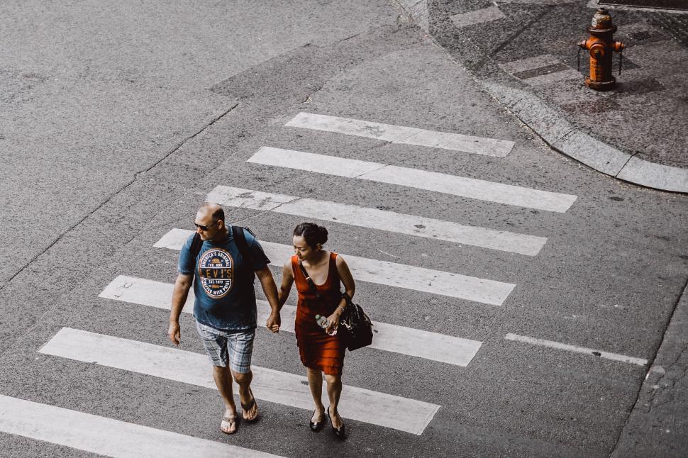 Free Stock Photo of Couple walking hand in hand across crosswalk on ...