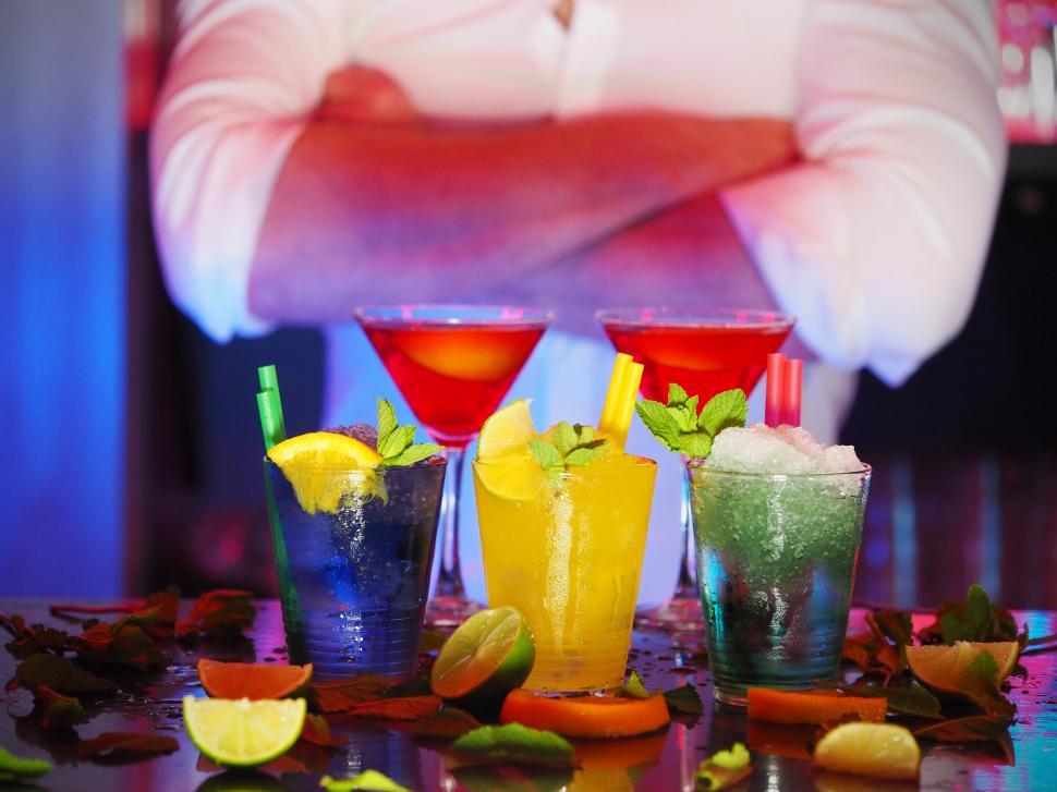 Free Stock Photo of Colorful cocktails display at a lively bar during a ...