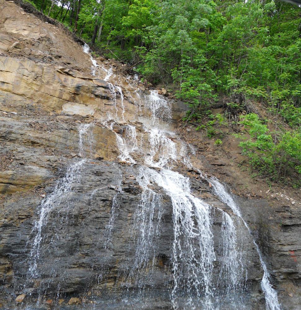 Free Stock Photo of Man Standing on Top of Waterfall Next to Lush Green ...
