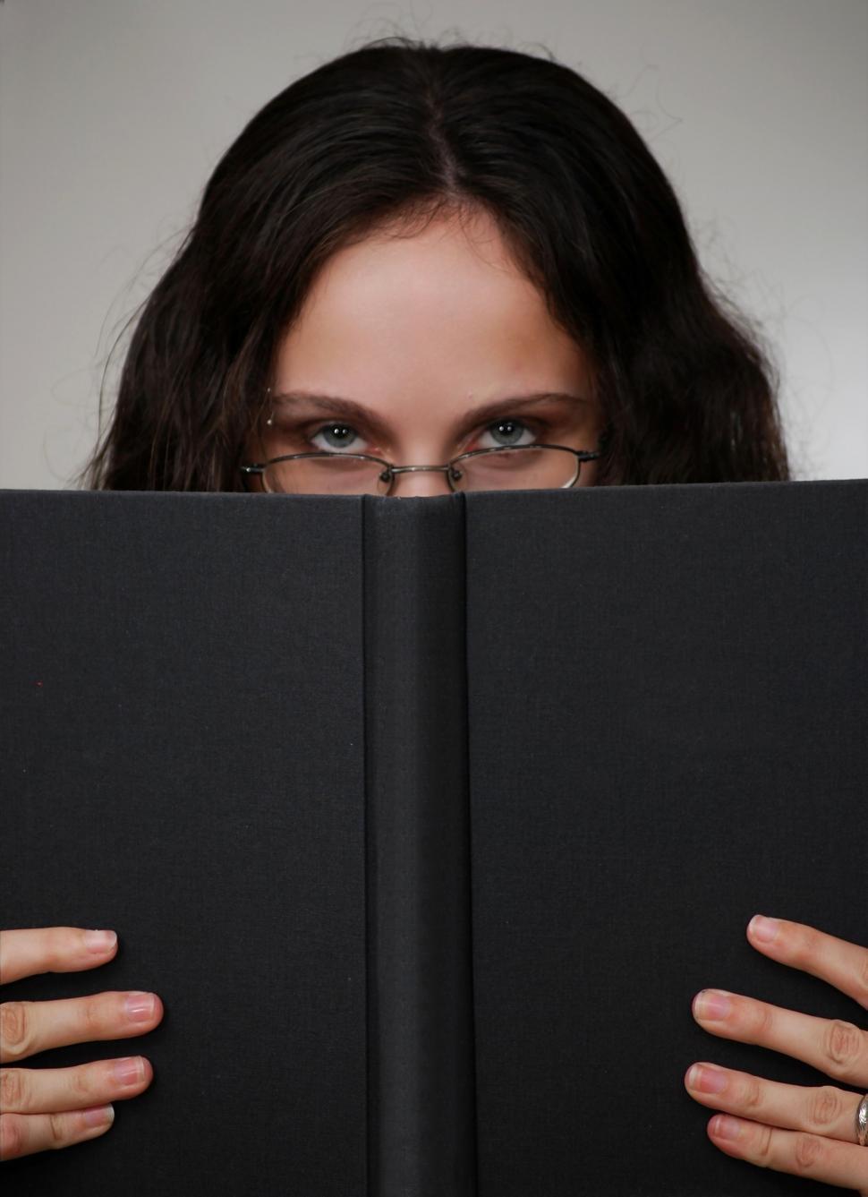 Free Stock Photo of A beautiful business woman looking over a book ...