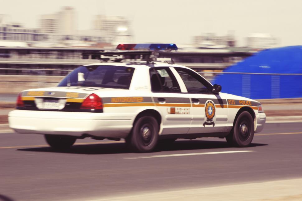 Free Stock Photo of Police Car Driving by Tall Building | Download Free ...