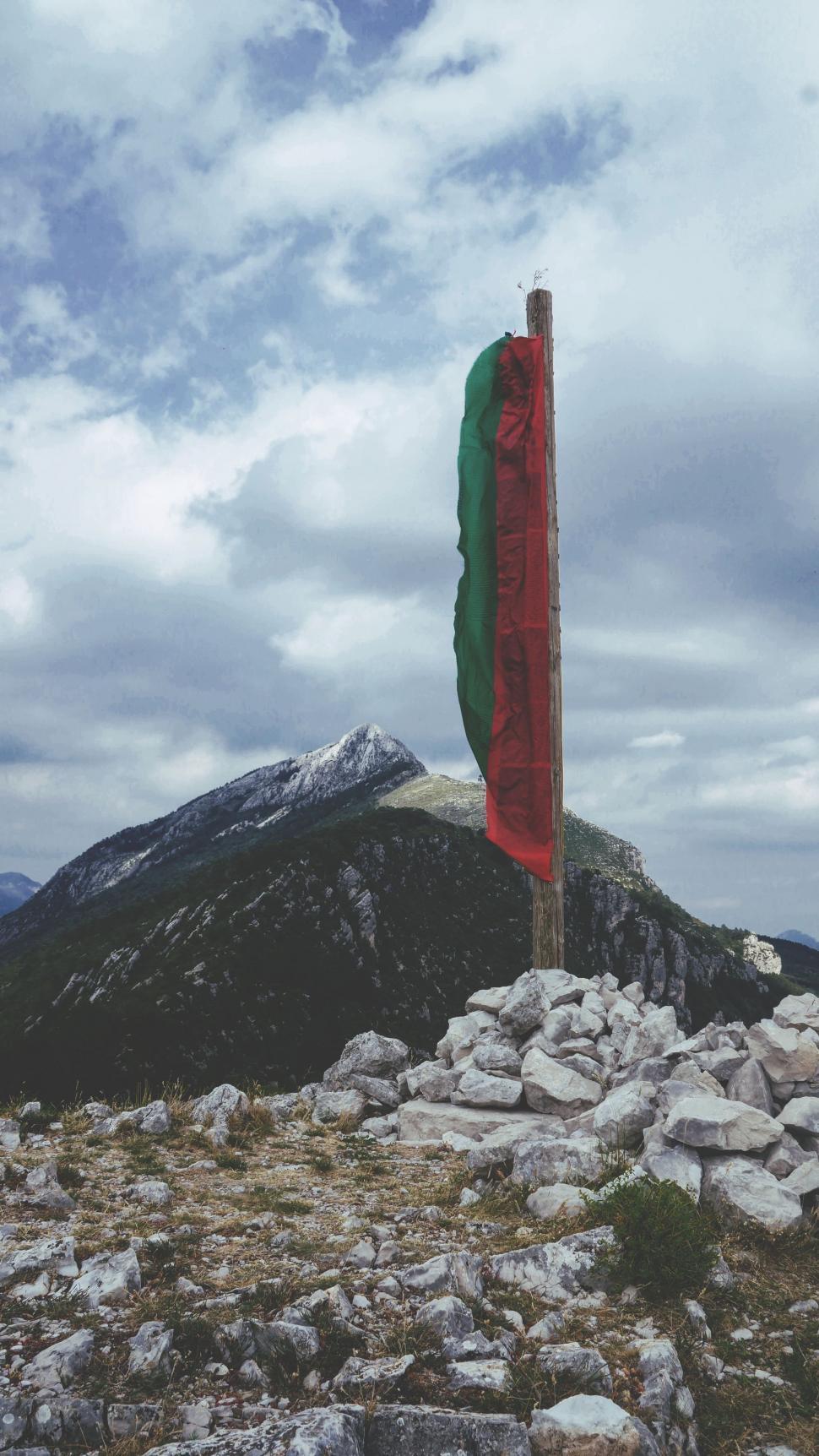Free Stock Photo of Flag Flying Atop Mountain on Cloudy Day | Download ...