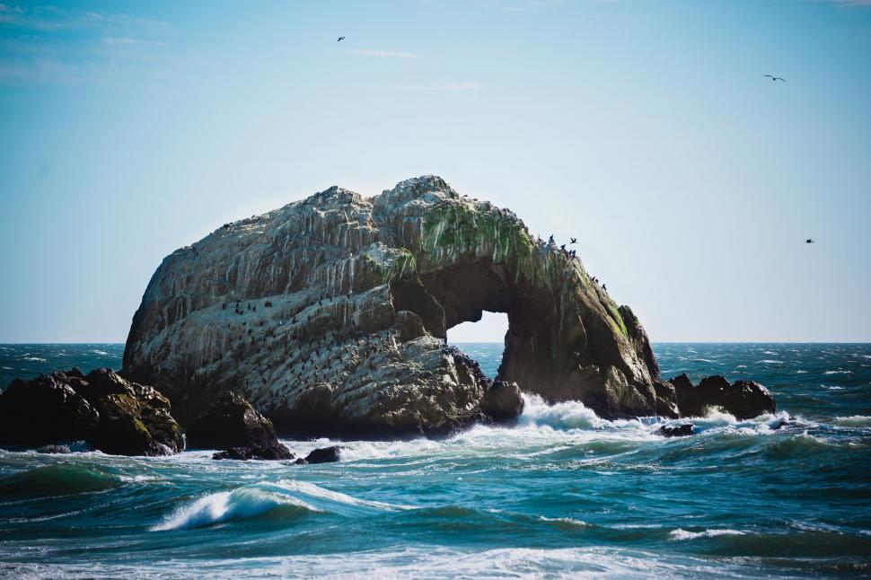 Free Stock Photo of Massive Rock Jutting in Ocean Waters | Download ...