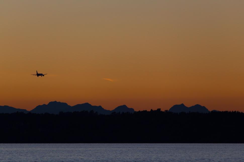 Free Stock Photo of Plane Flying Over Body of Water at Sunset ...
