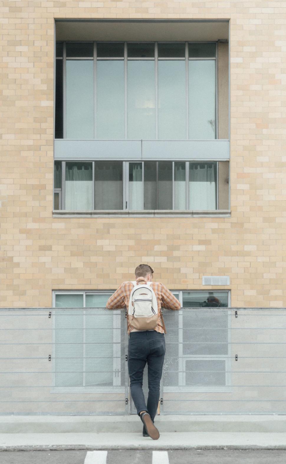 Free Stock Photo of Man Walking Down Street Next to Tall Building ...