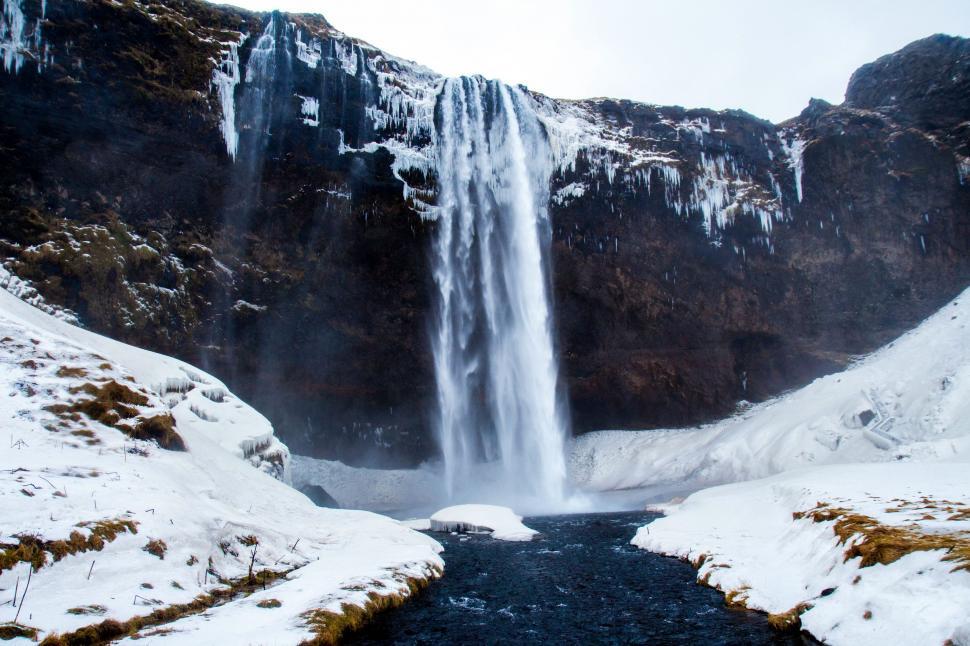 Free Stock Photo of Majestic Waterfall Surrounded by Snow | Download ...