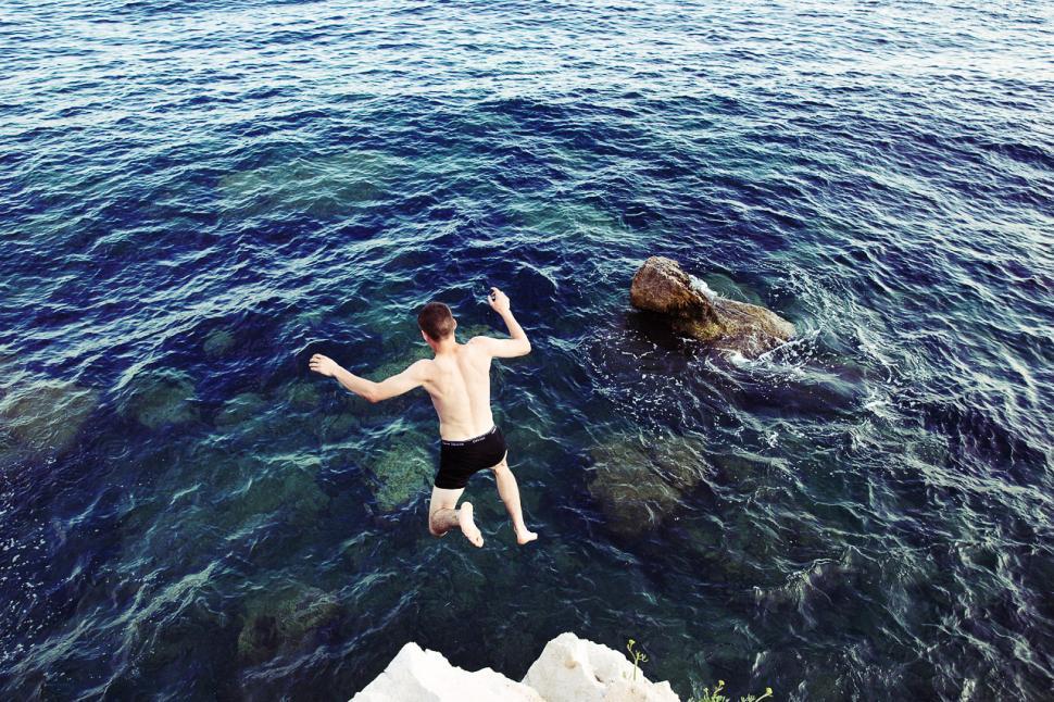 Free Stock Photo of Man Jumping Off Cliff Into Ocean | Download Free ...