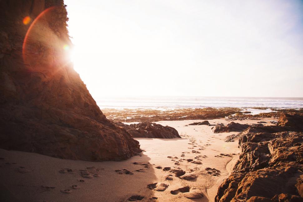 Free Stock Photo of Sun Shining Through Rocks on Beach | Download Free ...