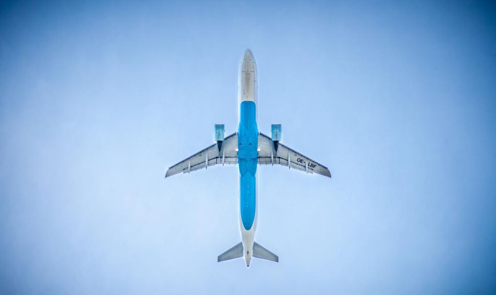 Free Stock Photo of Blue and White Jet Flying Through Blue Sky ...