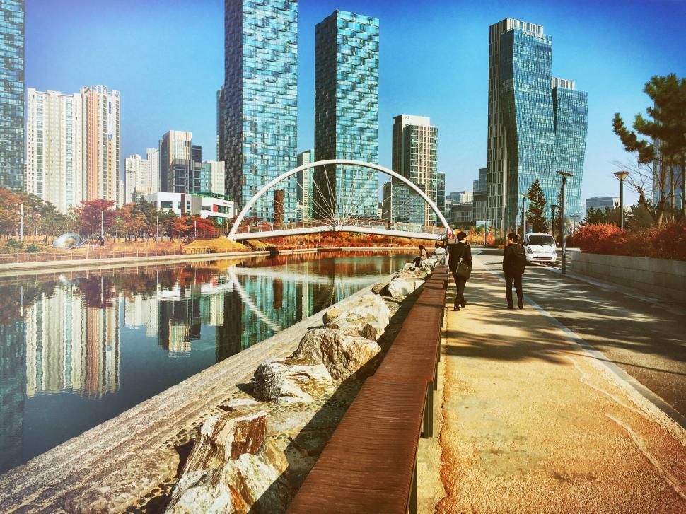 Free Stock Photo of Man Walking Down Sidewalk Along River | Download ...