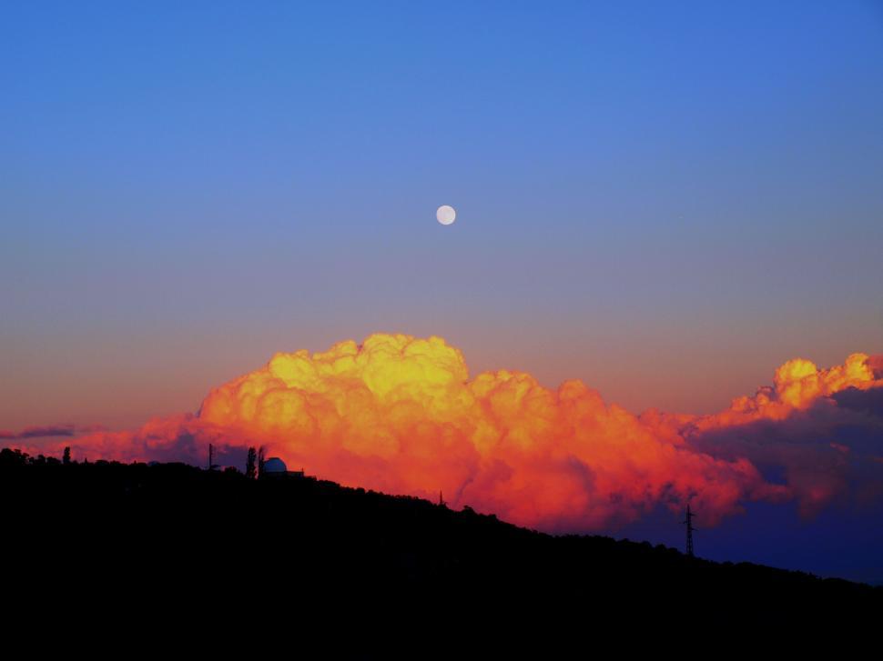 Free Stock Photo of Sun Setting Over Hill With Clouds | Download Free ...